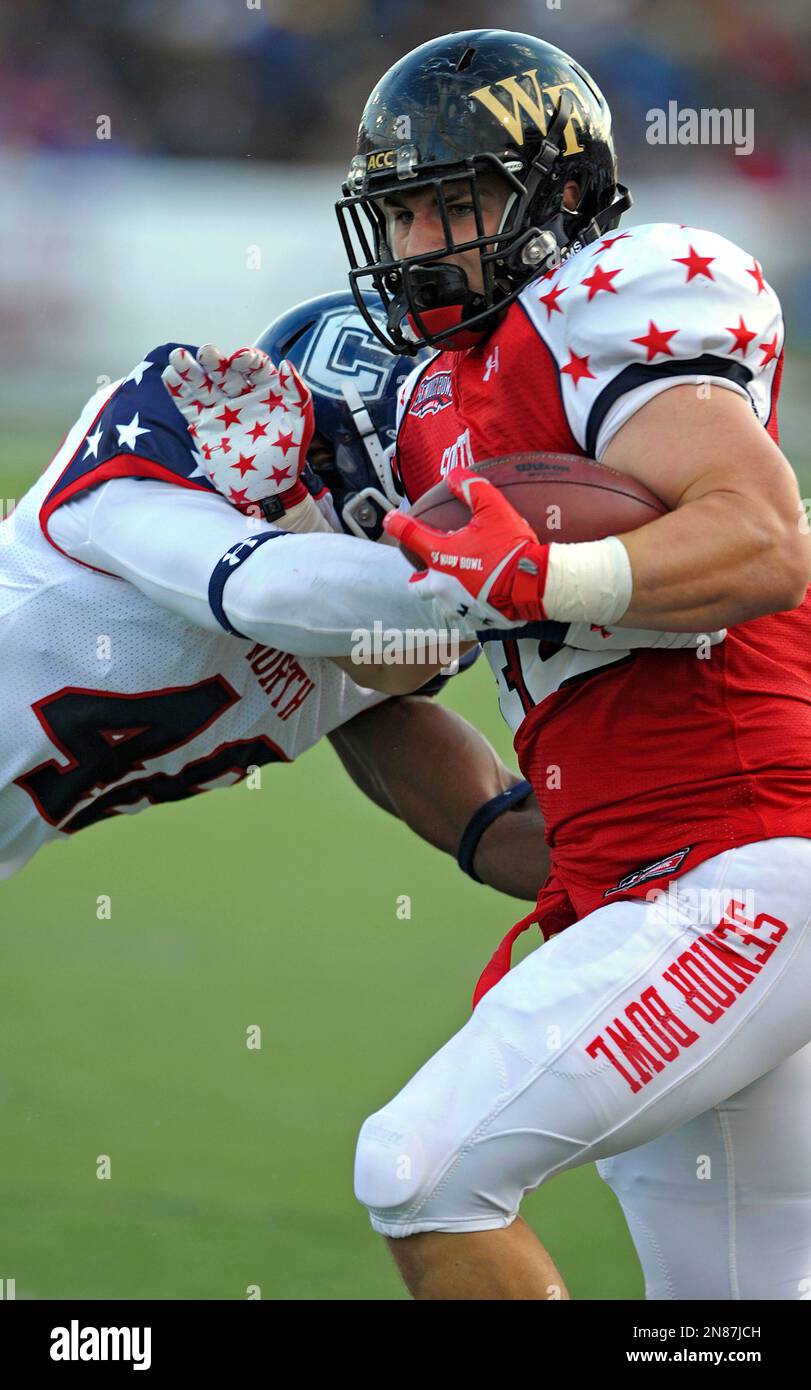 Senior Bowl South Squad fullback Tommy Bohanon of Wake Forest (42) ties ...