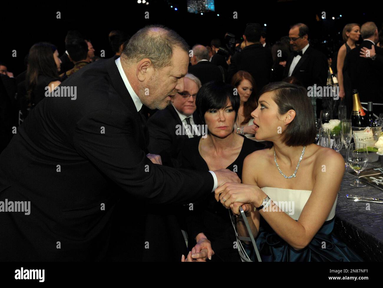 Harvey Weinstein, left, and Marion Cotillard, right, speak in the ...