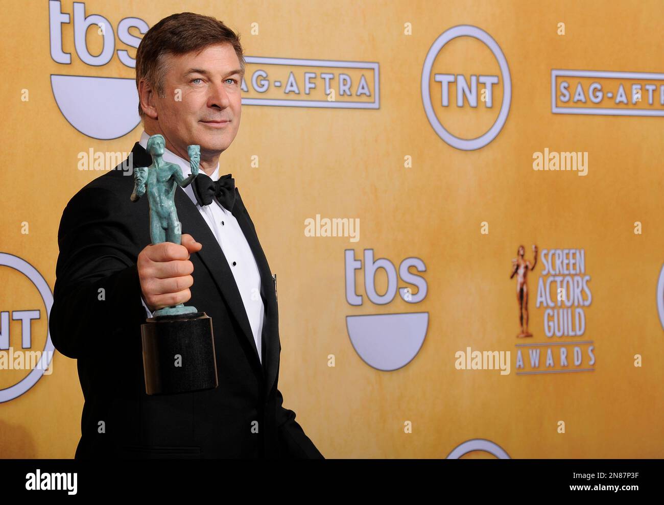Actor Alec Baldwin poses backstage with the award for best male actor ...