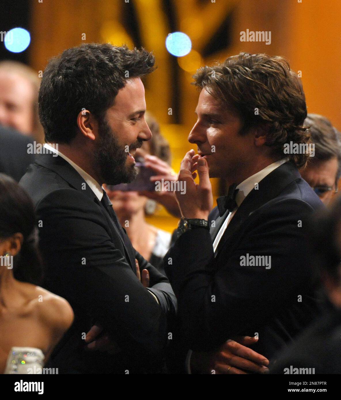 Ben Affleck, left, and Bradley Cooper speak in the audience at the 19th ...