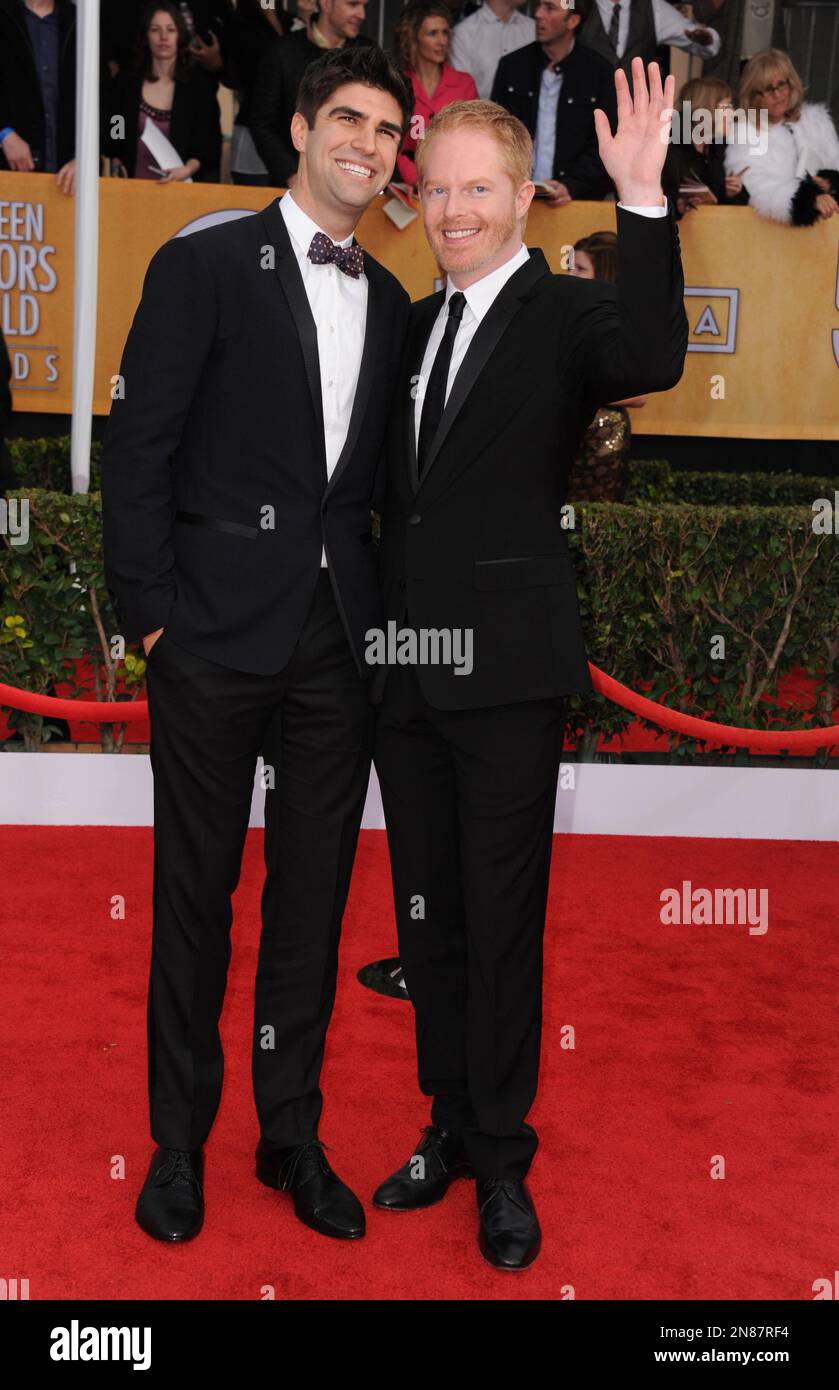 Justin Mikita, left, and actor Jesse Tyler Ferguson arrive at the 19th ...