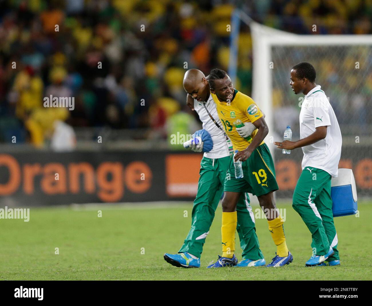 South Africa's May Mahlangu, center, is helped off the field by medics ...