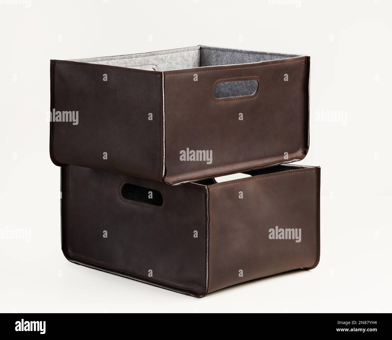 Two brown leather boxes with handles for storing things Stock Photo - Alamy
