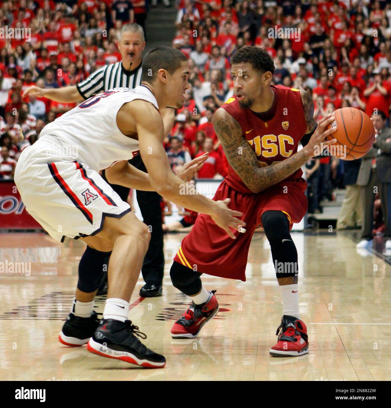 Southern California's J. T. Terrell, right, looks to pass the ball ...