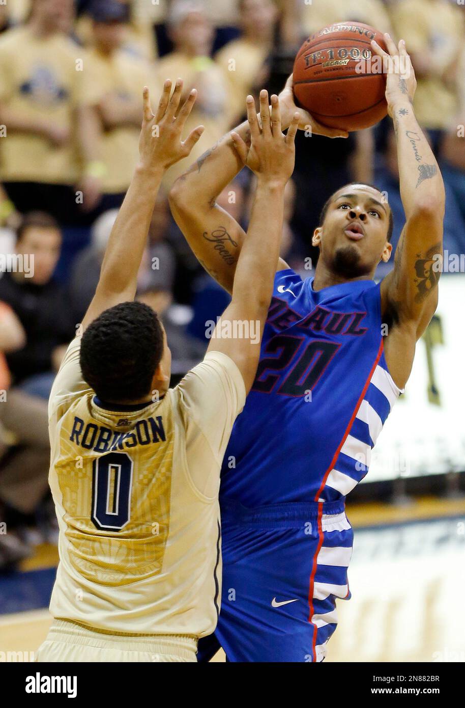 DePaul's Brandon Young (20) tries a shot around Pittsburgh's James ...