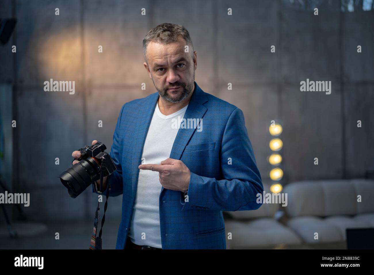 professional male photographer with digital photo camera in photo ...