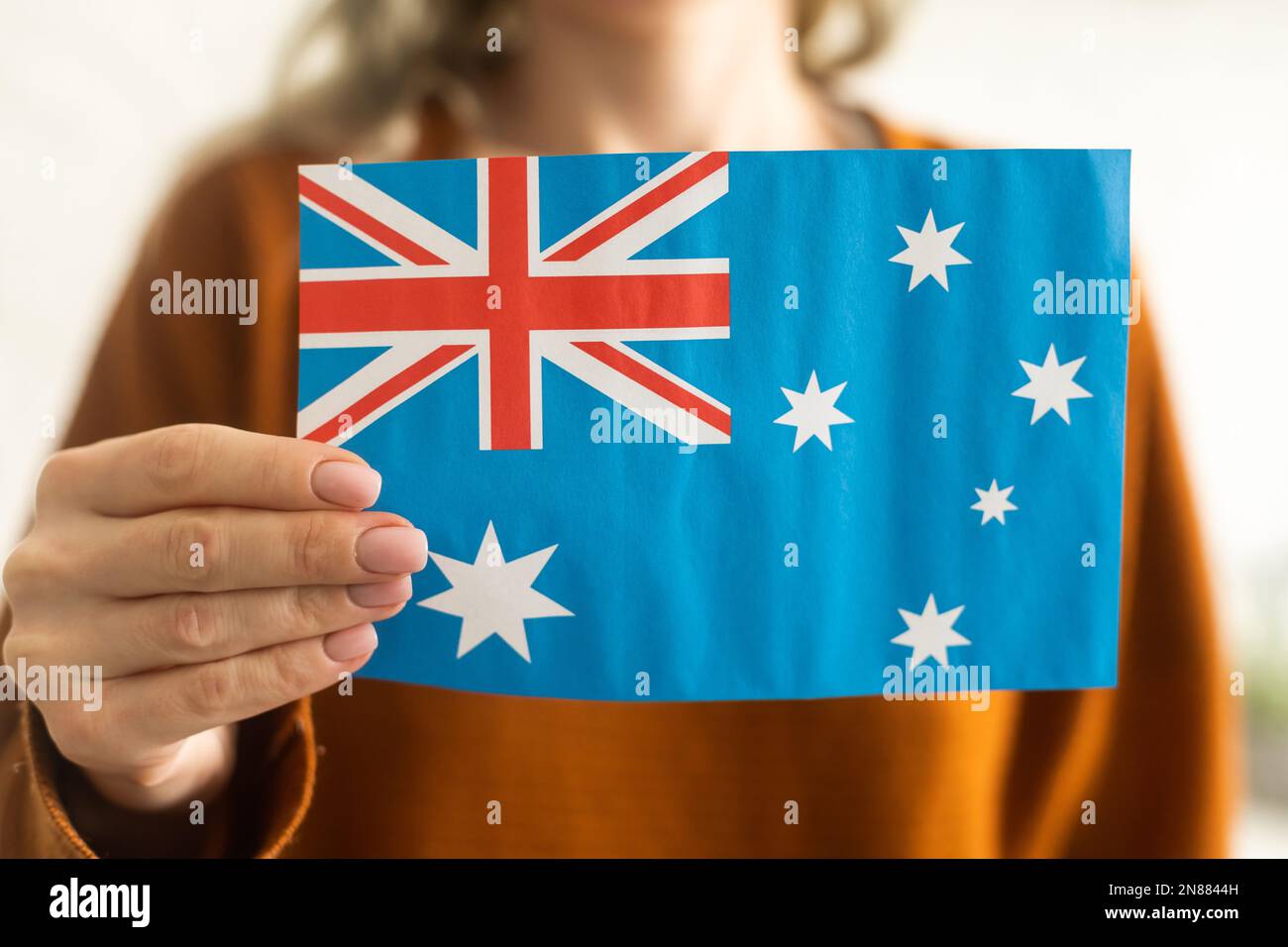 hand holding Australian flag, isolated on white background Stock Photo ...