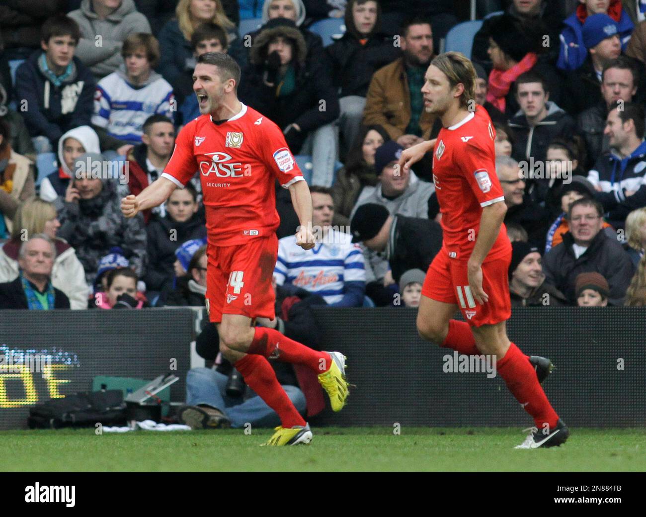 Milton Keynes Dons' Ryan Lowe, left, celebrates his goal against Queens ...