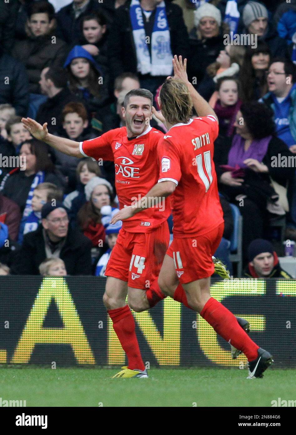 Milton Keynes Dons' Ryan Lowe, left, celebrates his goal against Queens ...