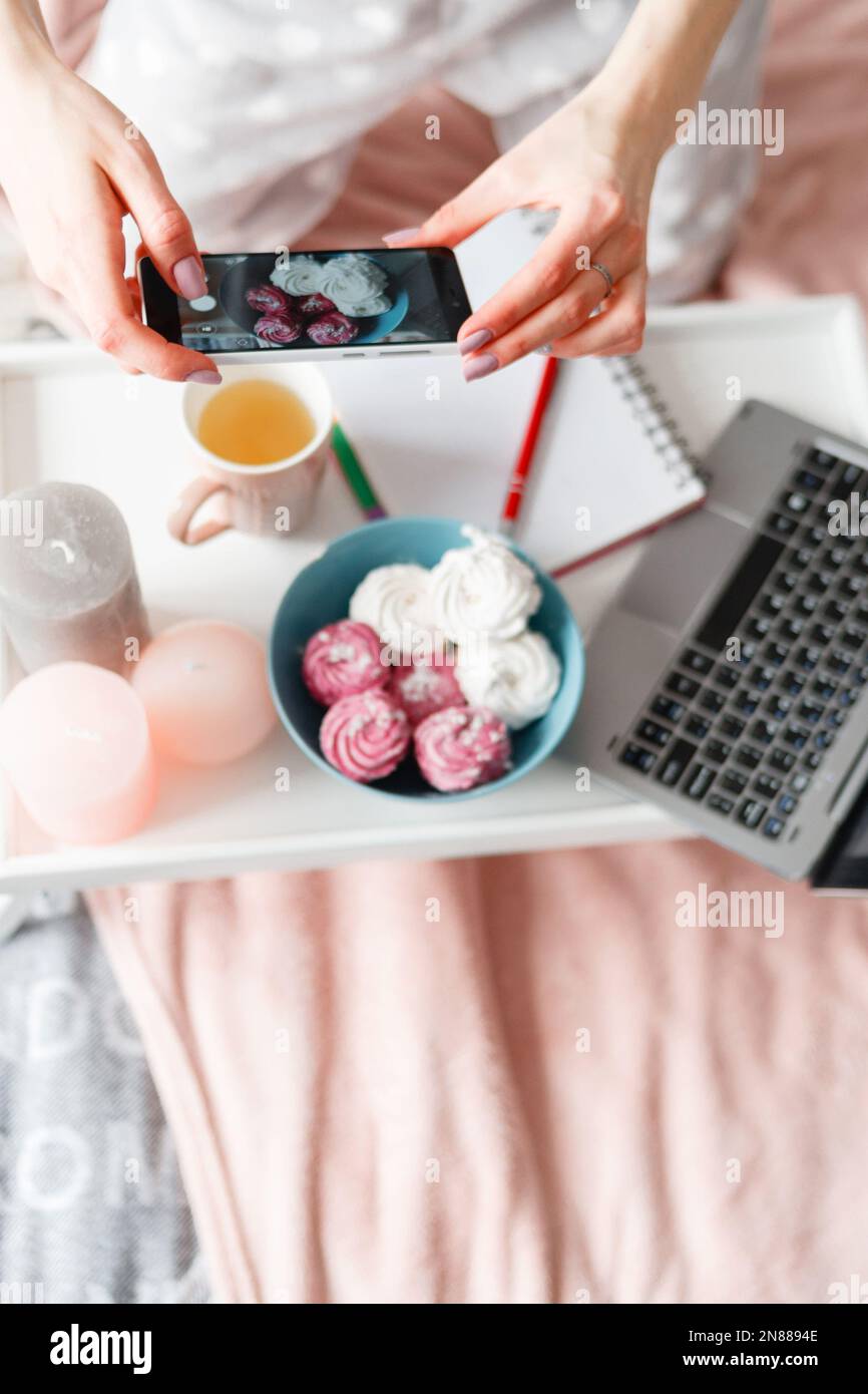 Unrecognizable woman makes photo of sweets Stock Photo - Alamy