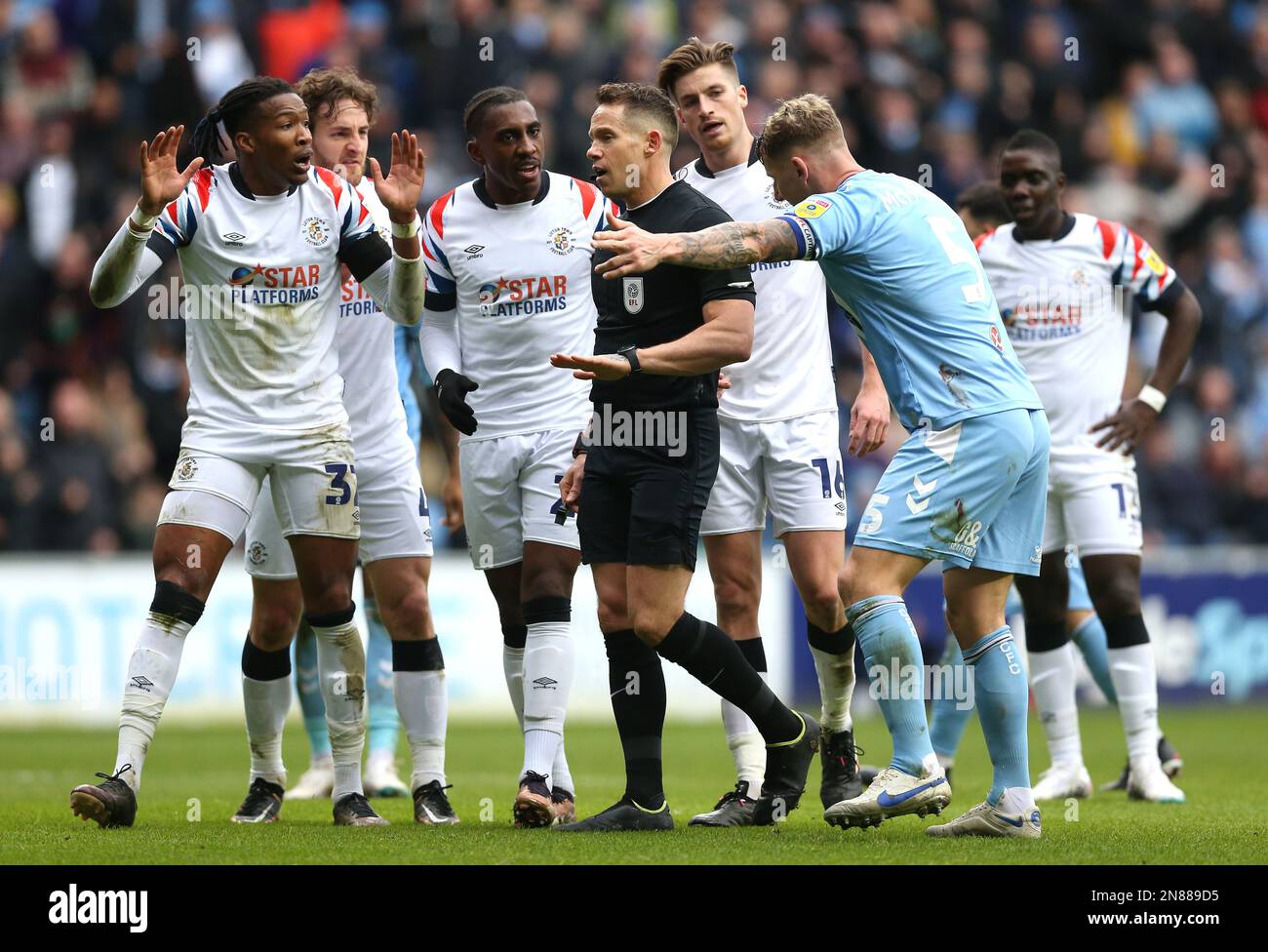 Coventry City and Luton Town players speak to referee Stephen Martin ...