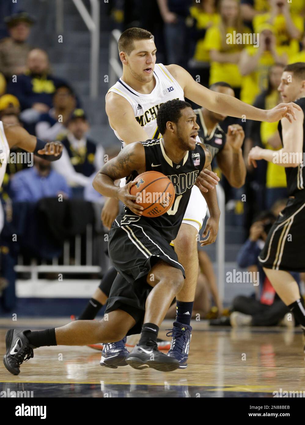 Purdue guard Terone Johnson (0) drives on Michigan forward Mitch McGary ...