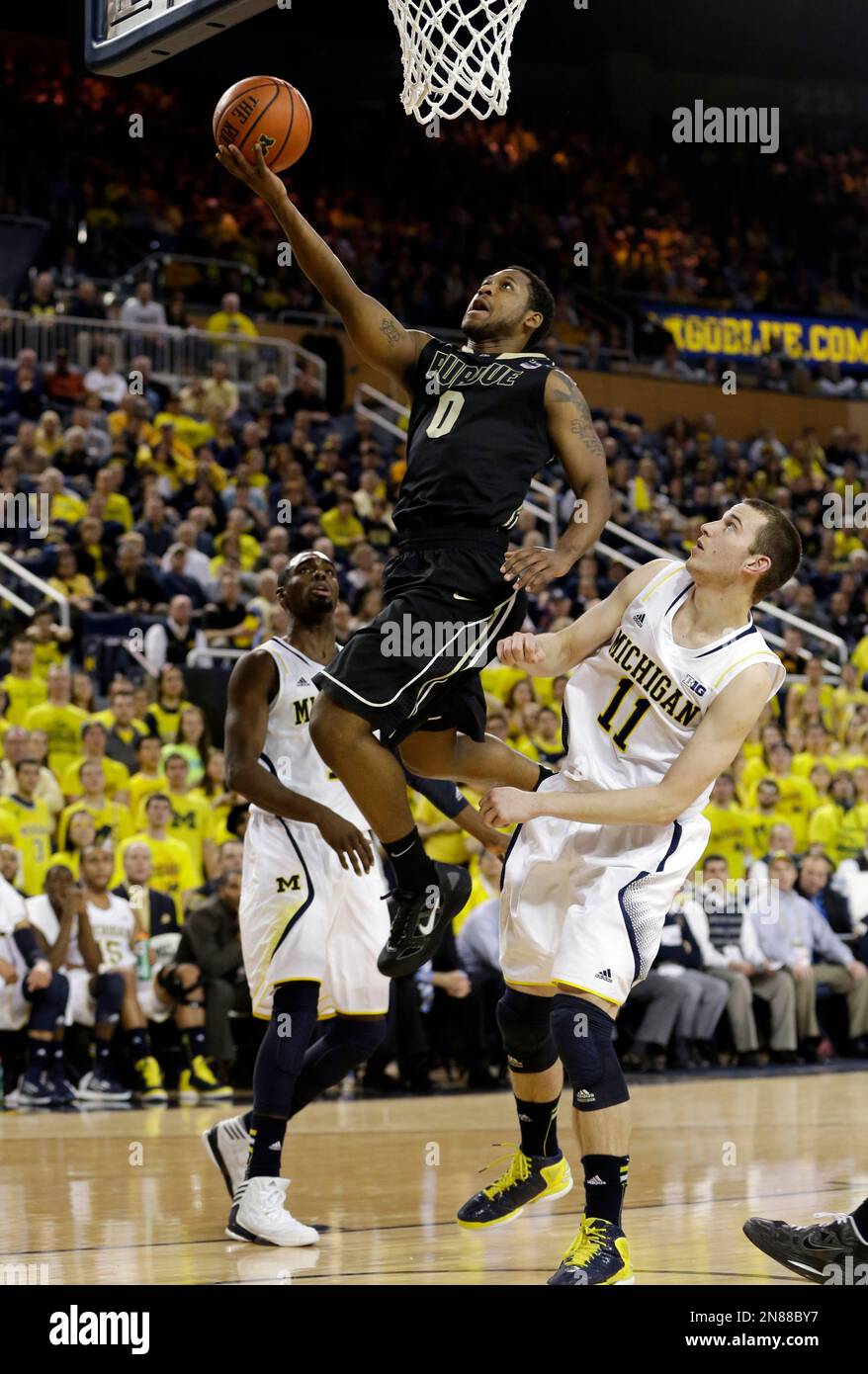 Purdue guard Terone Johnson (0) makes a layup between Michigan guard ...