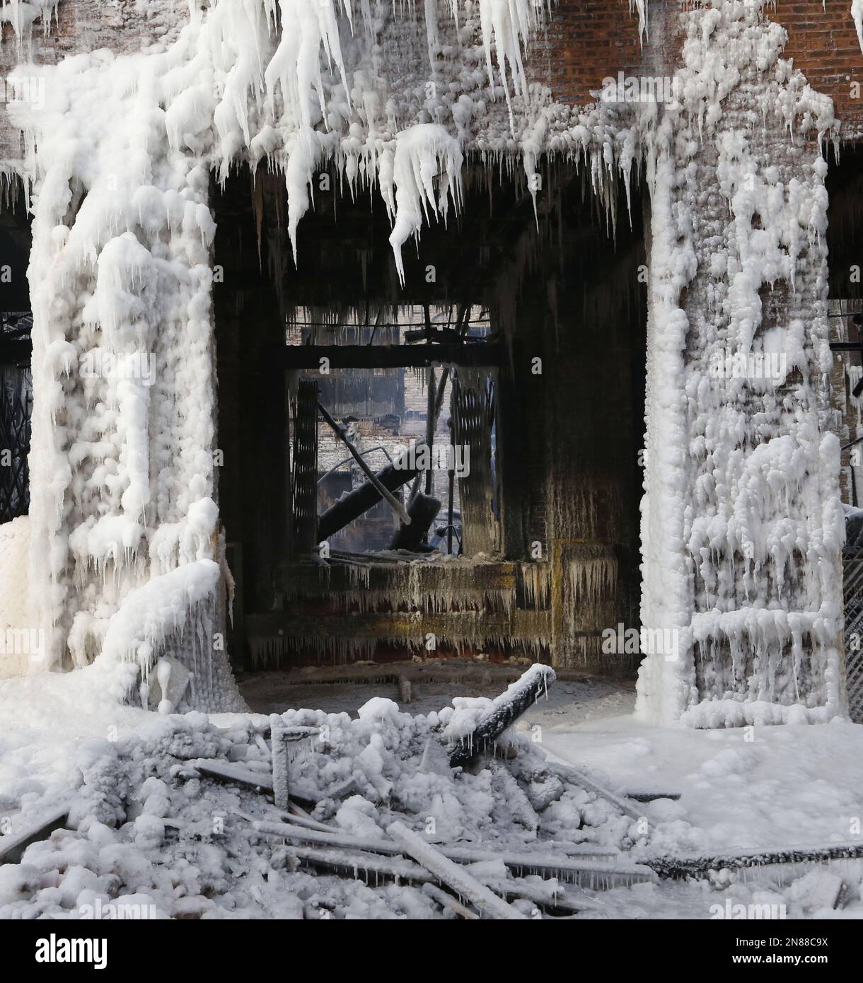 Freezing temperature form icicles in a door frame on a fire gutted ...