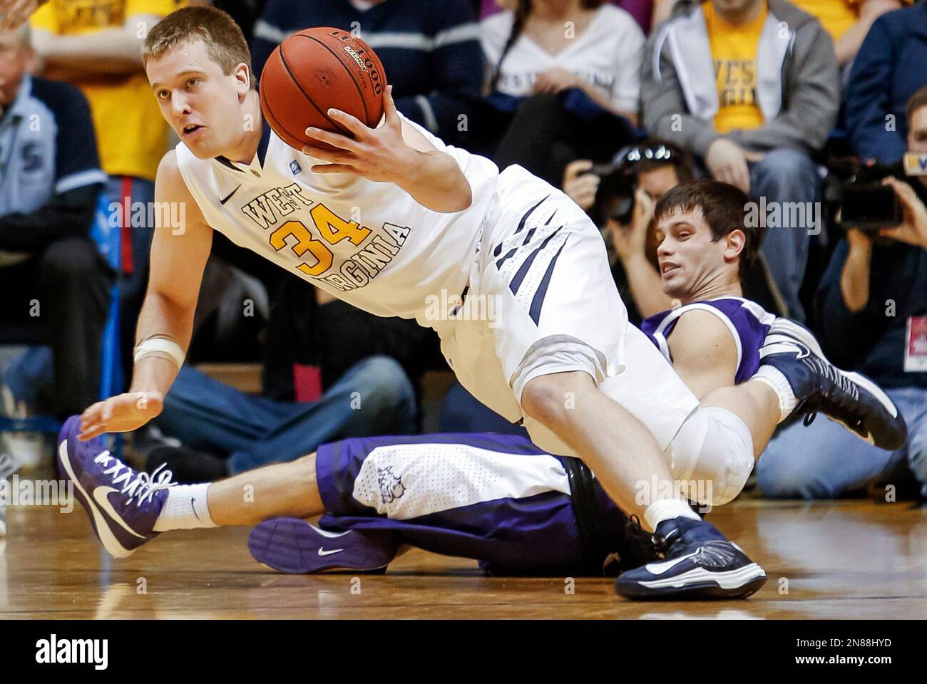 West Virginia's Kevin Noreen (34) and TCU's Chris Zurcher, right ...