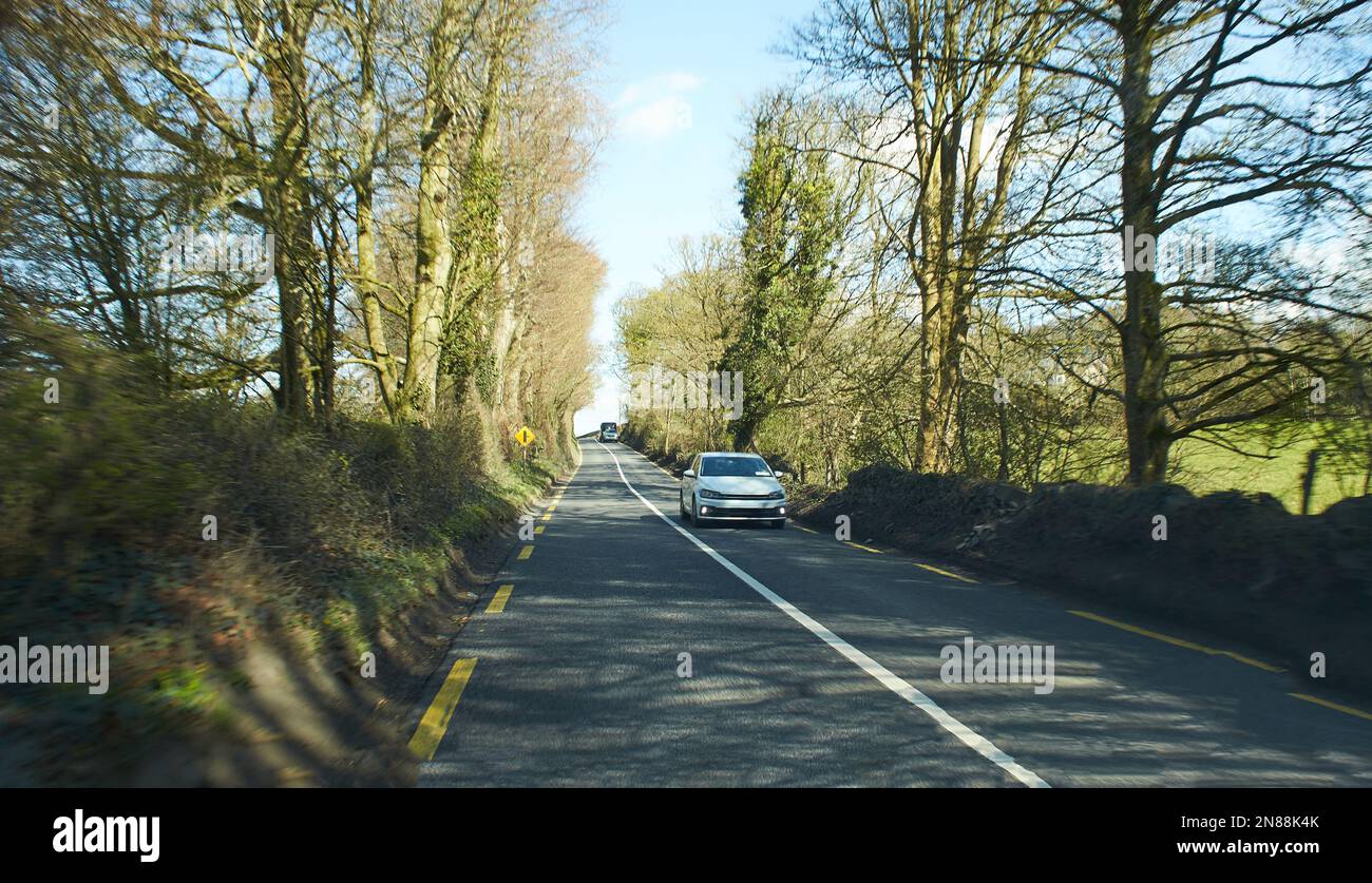 Rear view of cars driving on motorway, Ireland. Road with metal safety ...