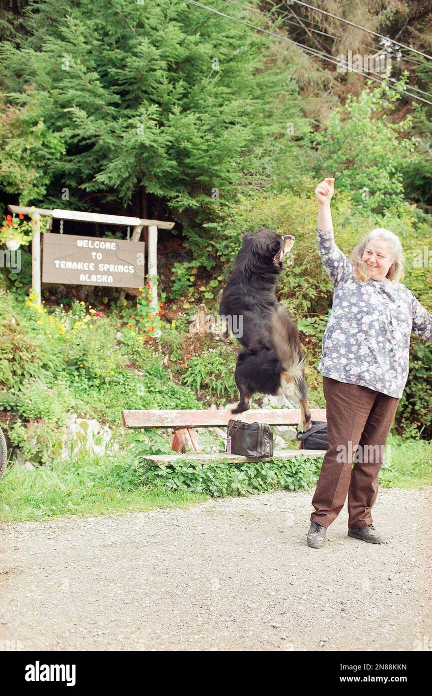 Pam Nelson plays with her dog, Grizz, along Main Street in Tenakee ...