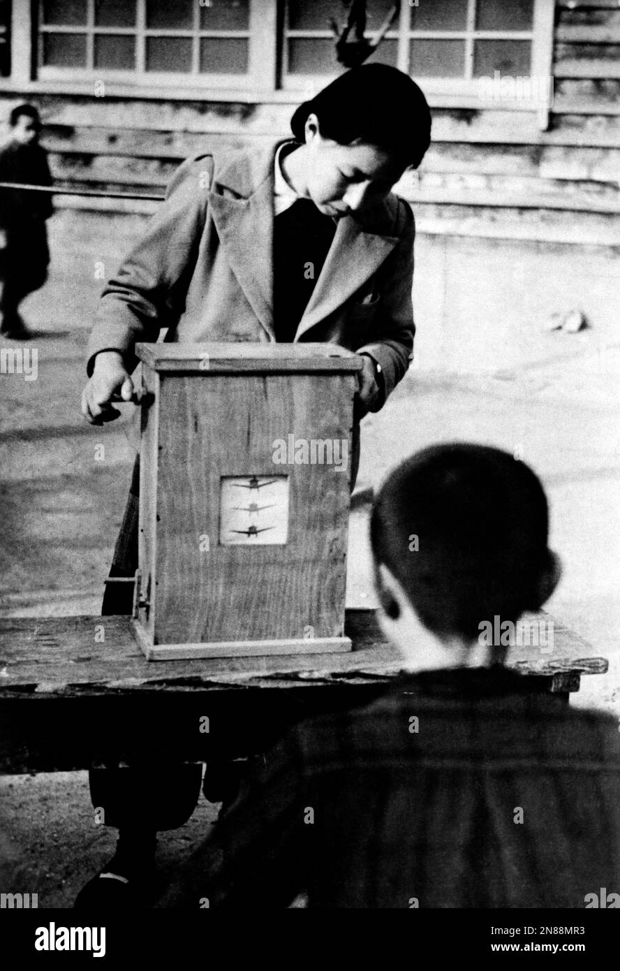 A teacher uses a machine to teach students how to recognize Japanese ...