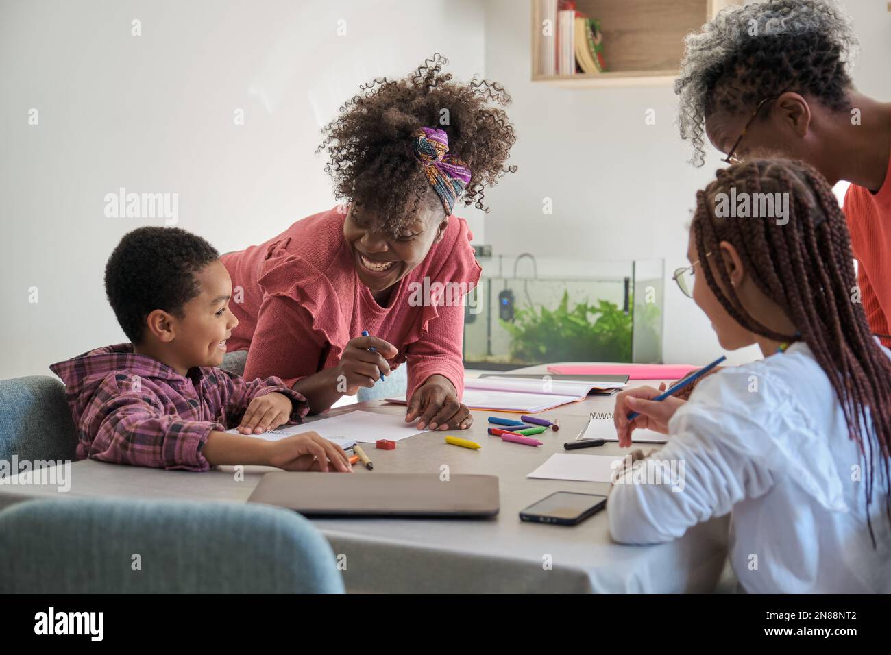 African mothers helping children do their homework Stock Photo - Alamy