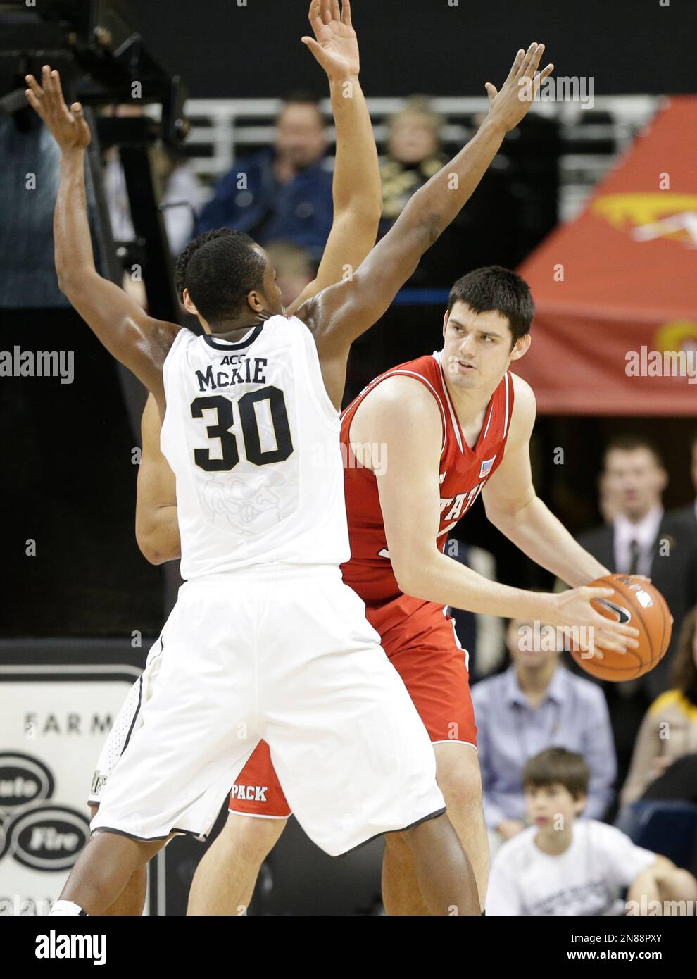 North Carolina State's Jordan Vandenberg, right, looks to pass around ...