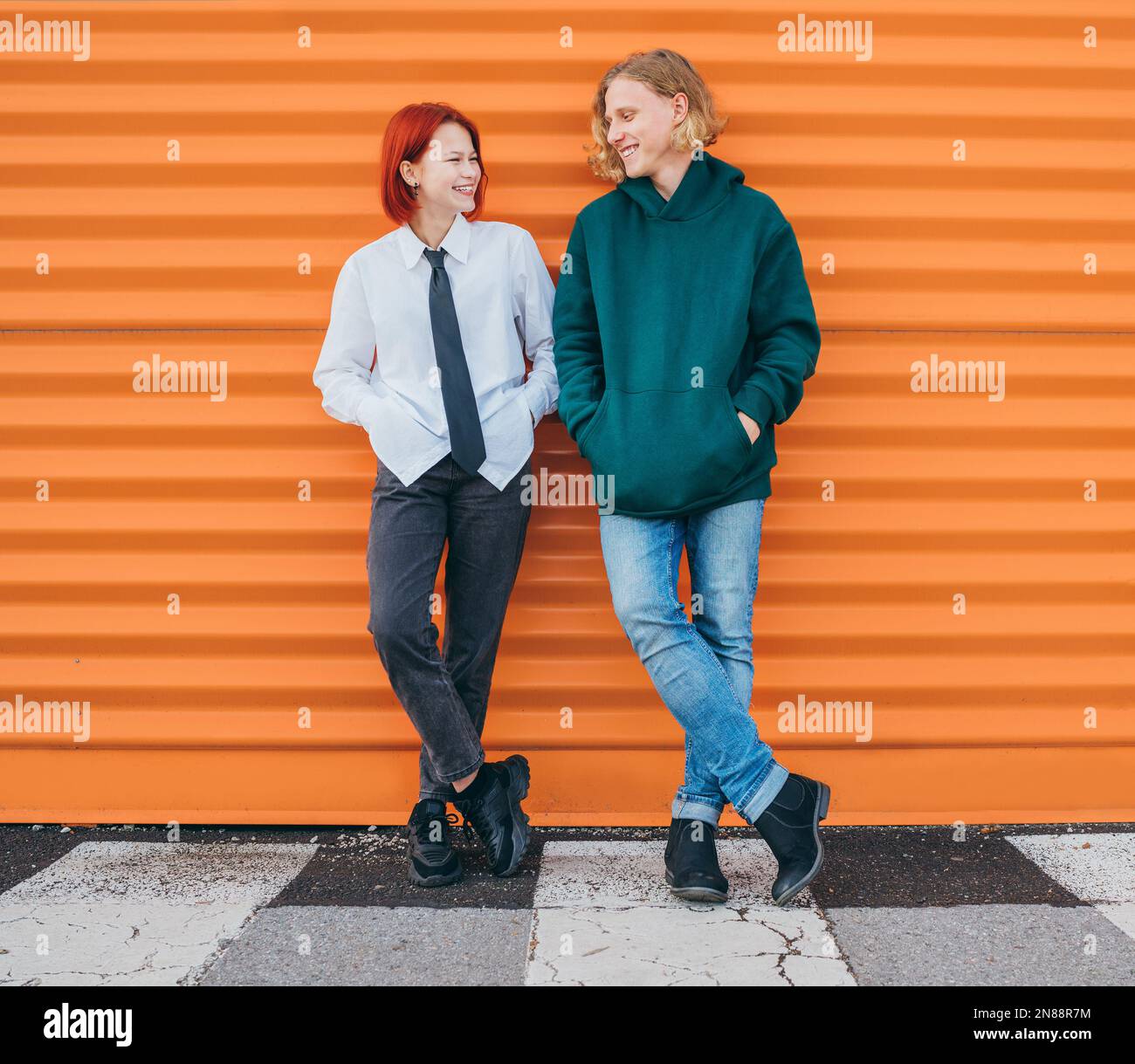 Portraits of two smiling to each other caucasian teen friends boy and ...
