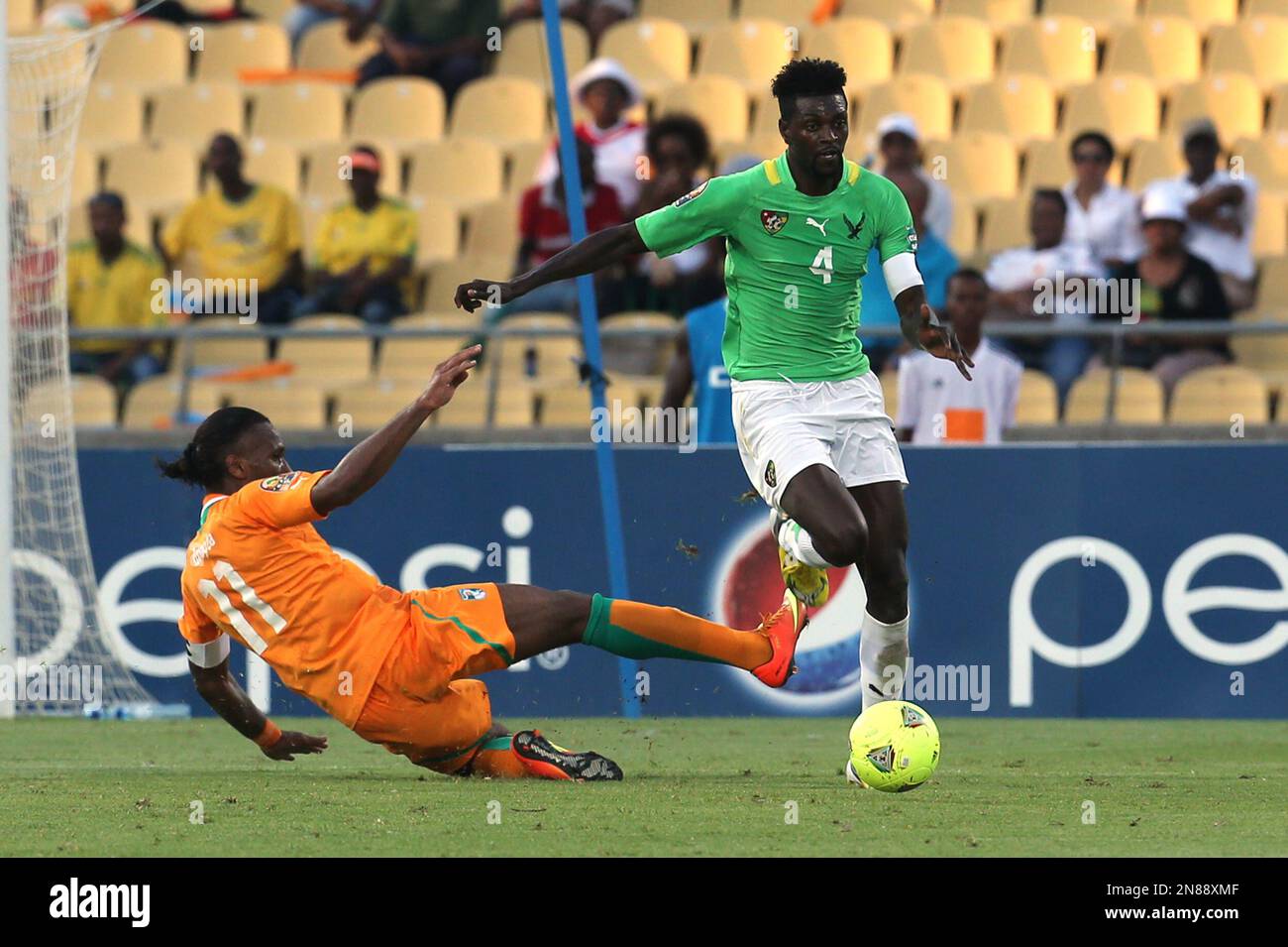 Togo's Emmanuel Adebayor, right, defends against Ivory Coast's Didier ...