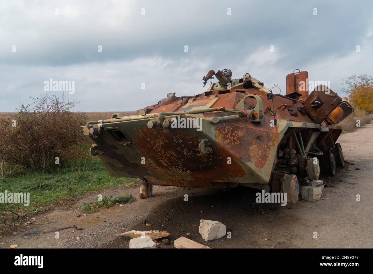 Countryside. After the battle. Destroyed burnt combat vehicle stands on ...