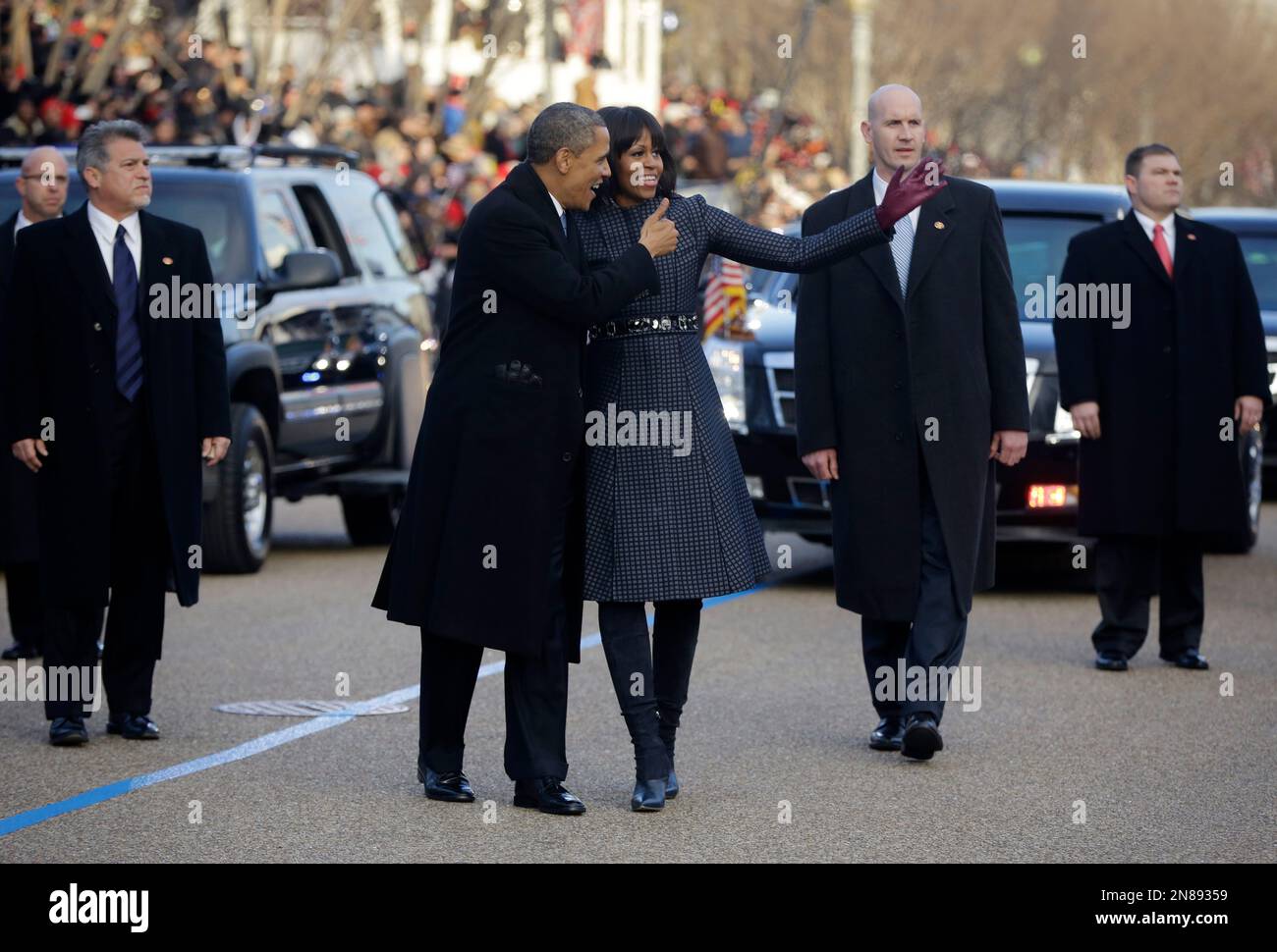 President Barack Obama and first lady Michelle Obama walk in the parade ...