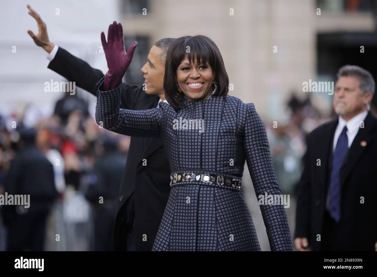President Barack Obama and first lady Michelle Obama walk in the parade ...