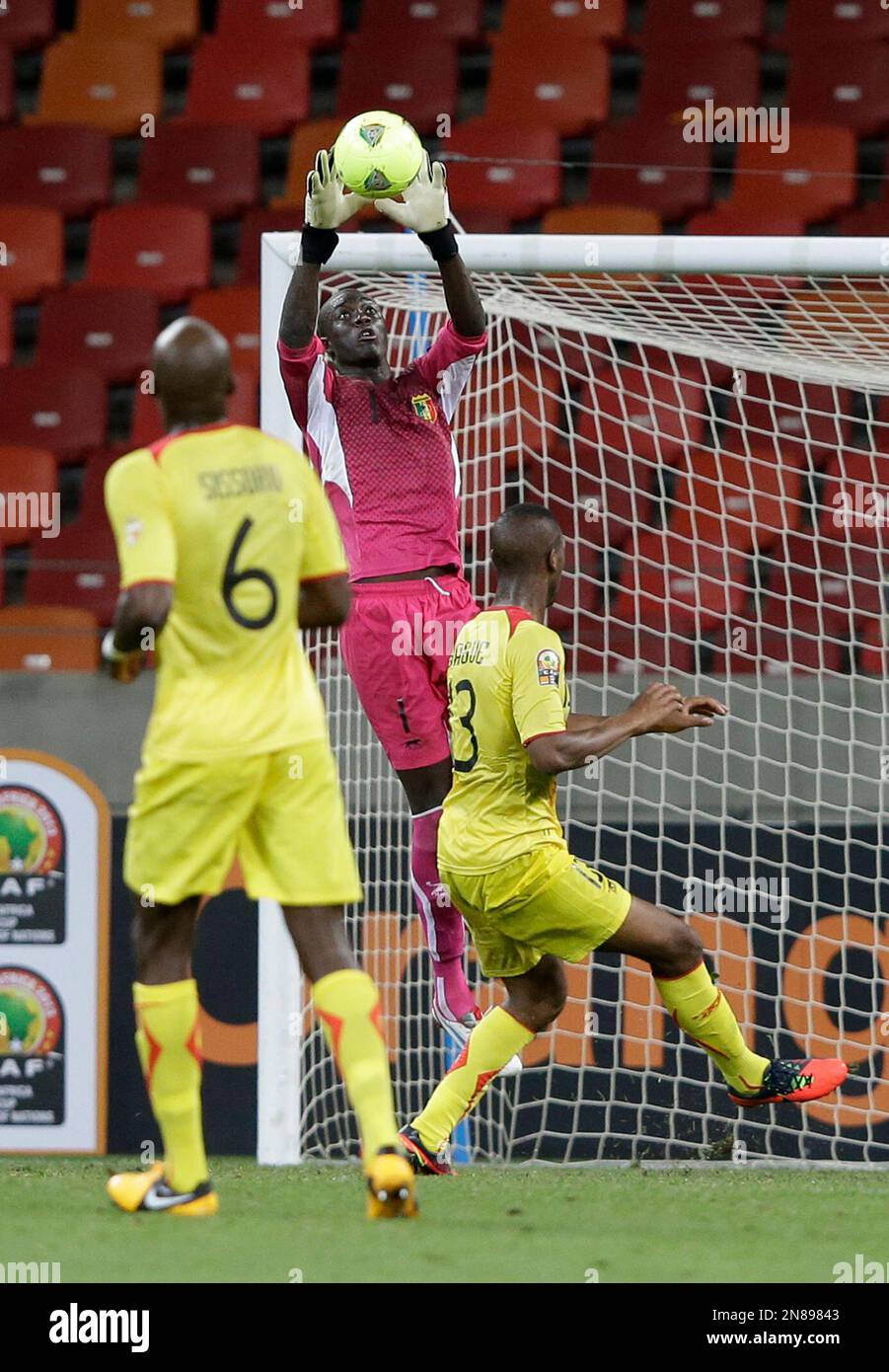 Mali's goalkeeper Mamadou Samassa stops the ball as teammates Molla ...