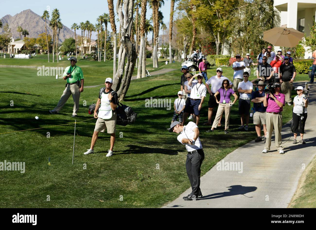 Kevin Chappell, foreground, hits out of the rough on the sixth hole ...