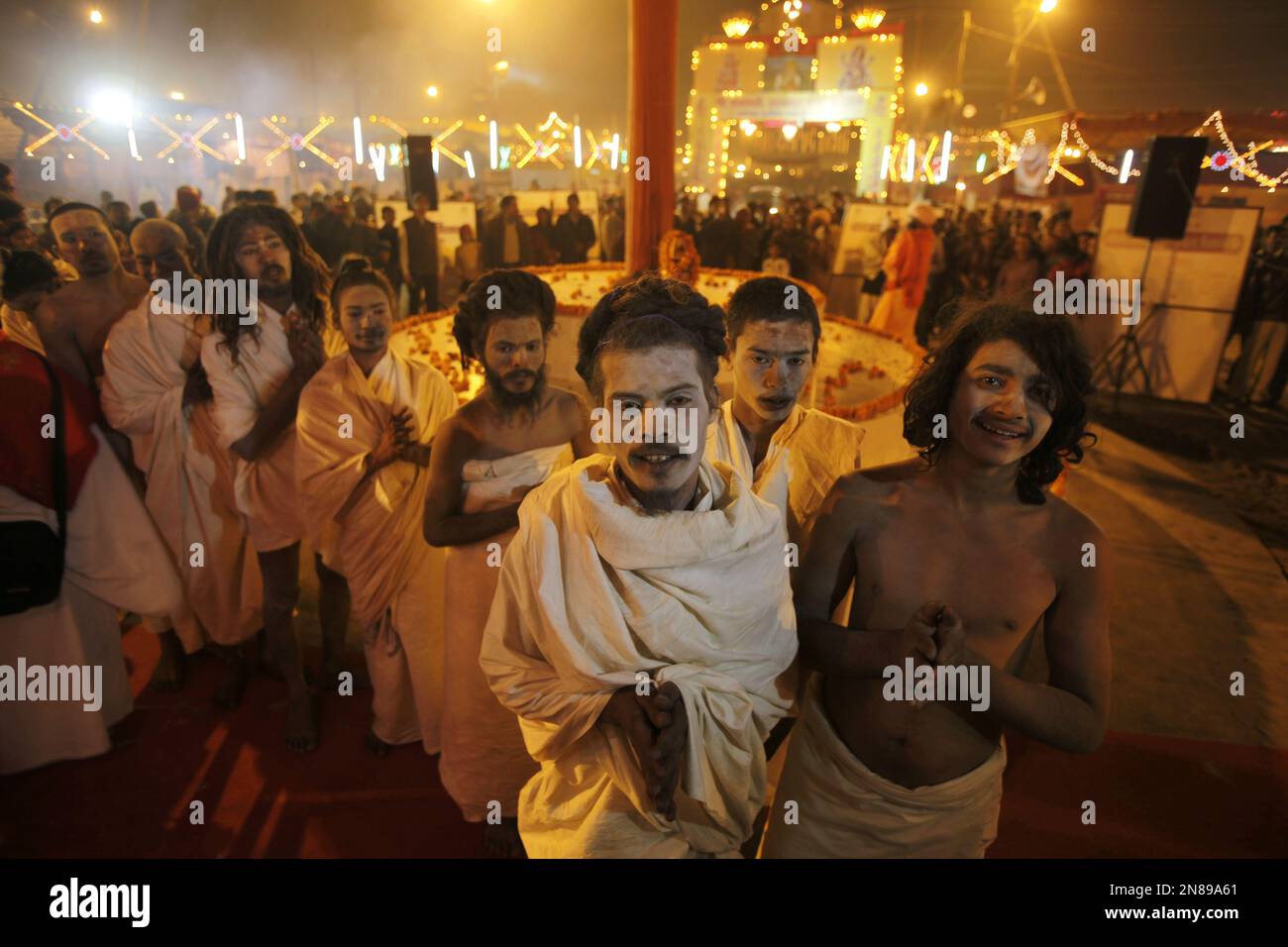 Hindu holy men perform evening prayers at Sangam, the confluence of the ...
