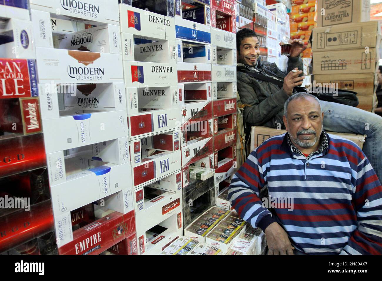 Egyptian vendors display imported cigarettes at a popular market in ...