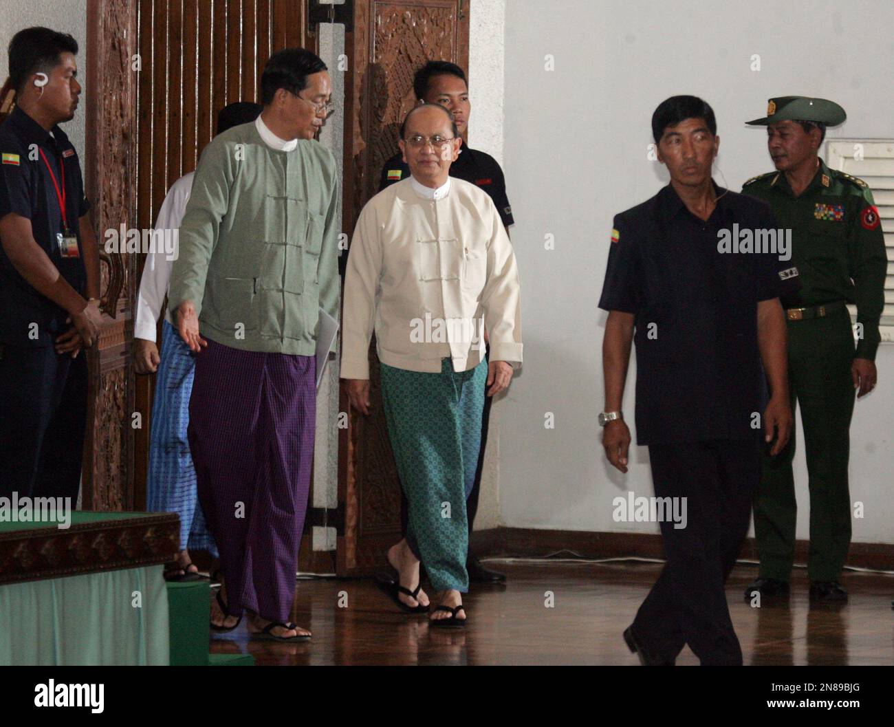 Myanmar President Thein Sein, center arrives for a meeting with members ... Myanmar President Thein Sein, center arrives for a meeting with members ...