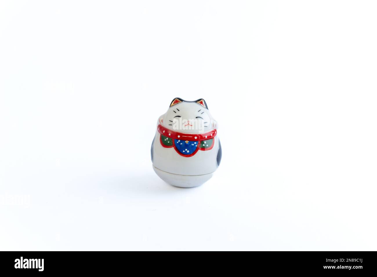 A Maneki-neko or also known as fortune cat in porcelain. Symbolizing ...