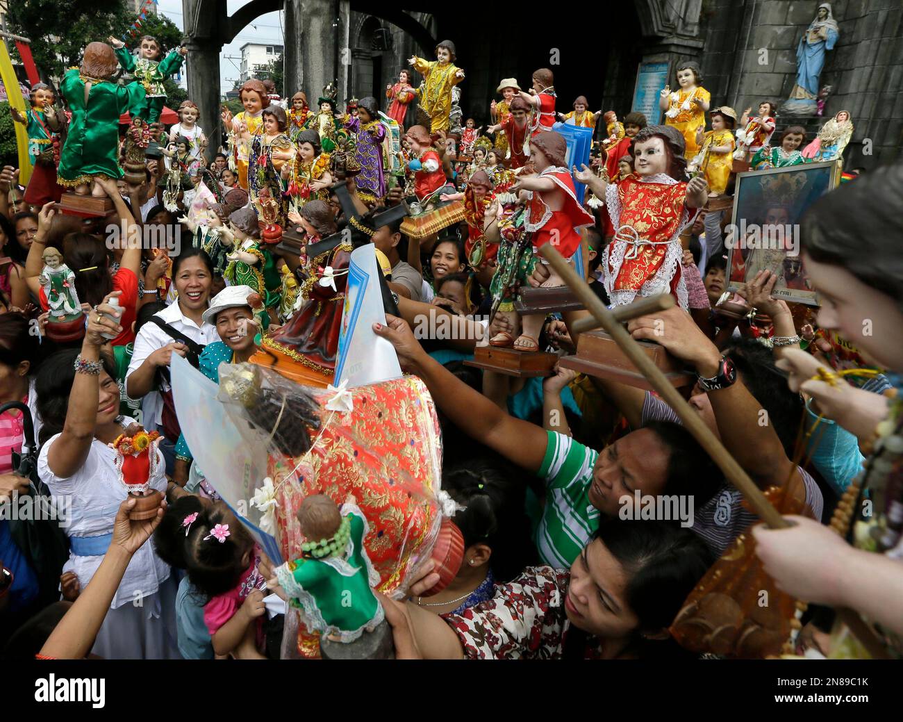 Roman Catholic devotees raise their images of the Infant Jesus for ...