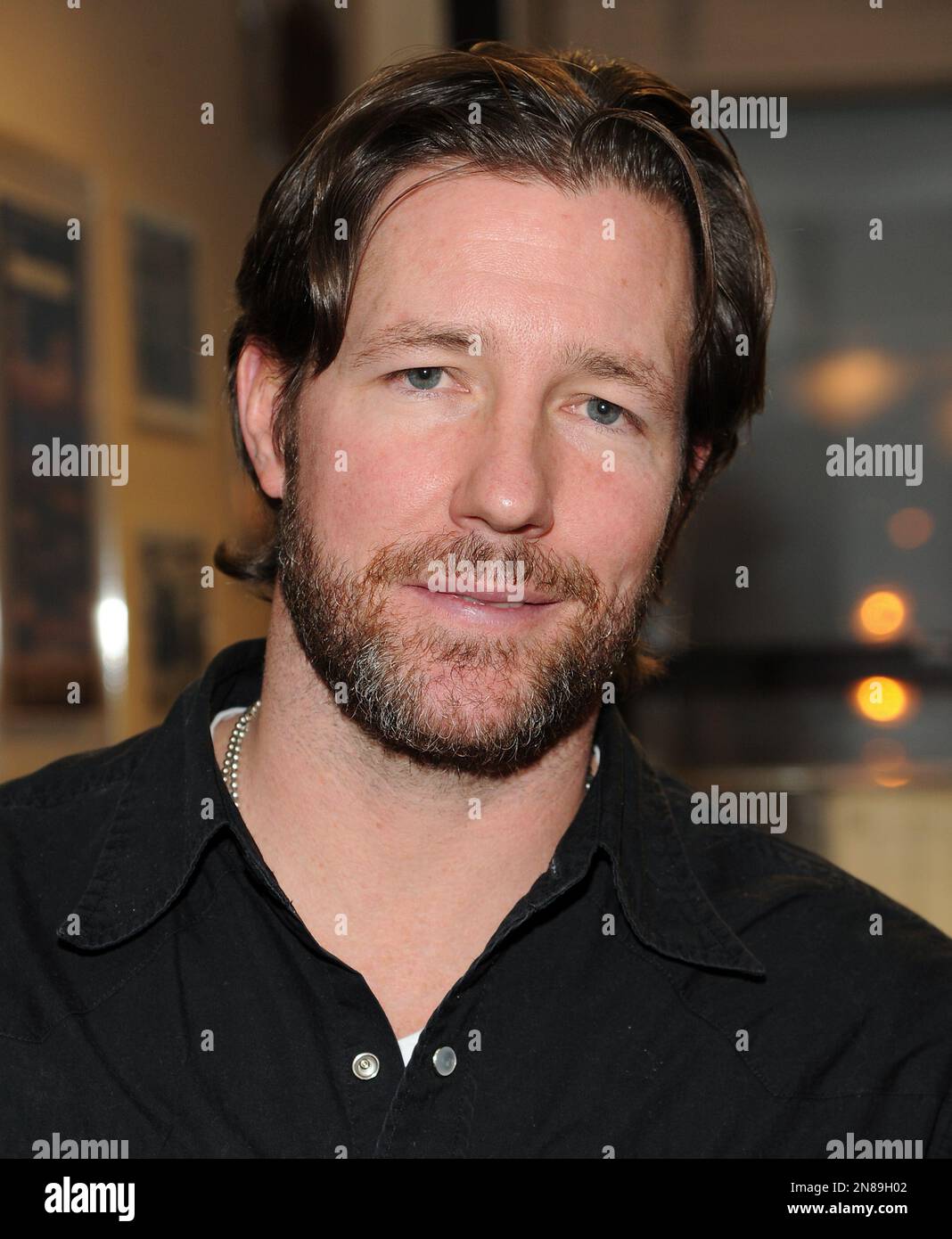 Filmmaker Ed Burns poses in front of a poster for his first film "The ...