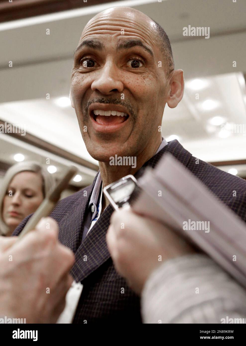 Former NFL coach Tony Dungy, left, speaks to reporters at the NCAA ...