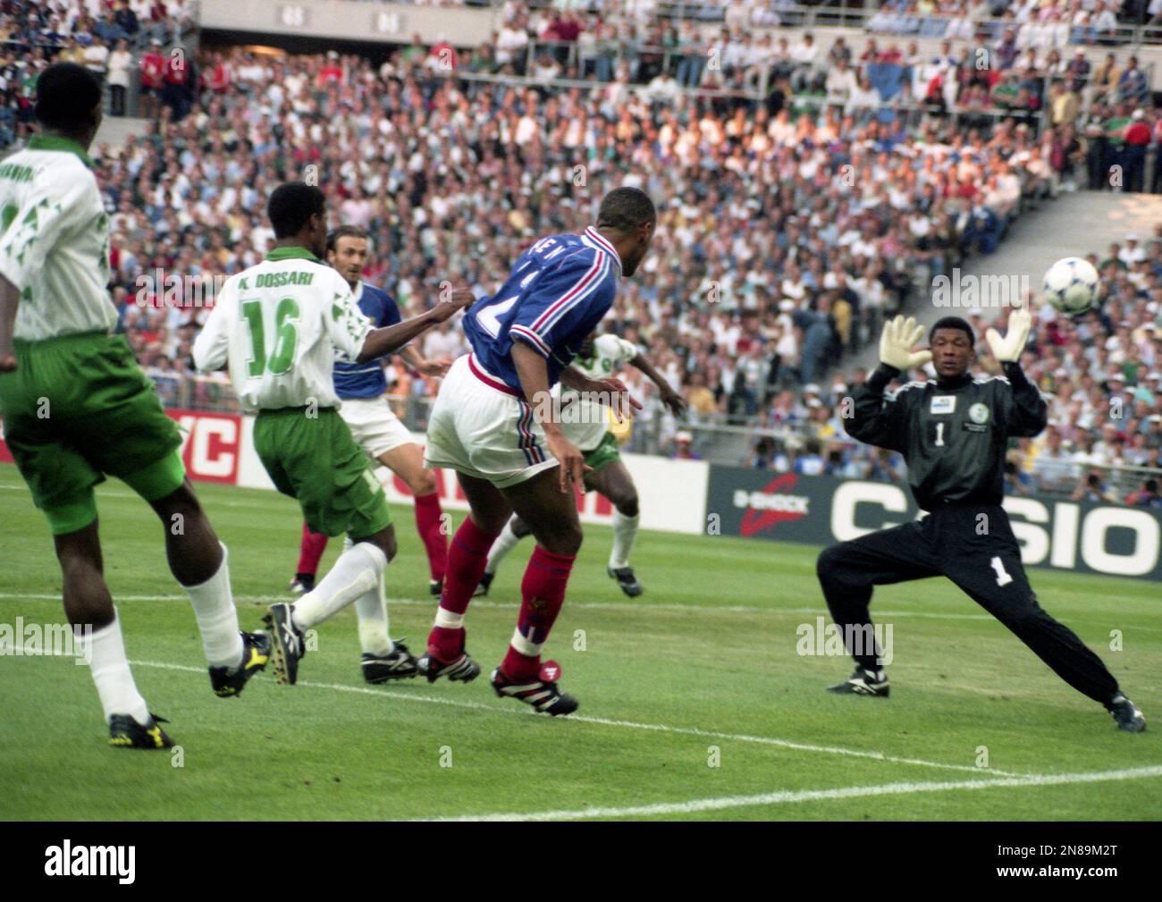 France's forward Thierry Henry, center, jumpes for a header past Saudi ...