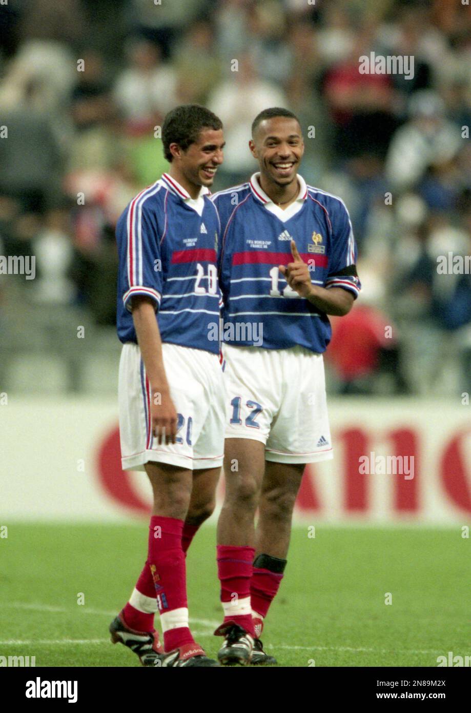 France's forward Thierry Henry, smiles as he leaves the pitch with his ...