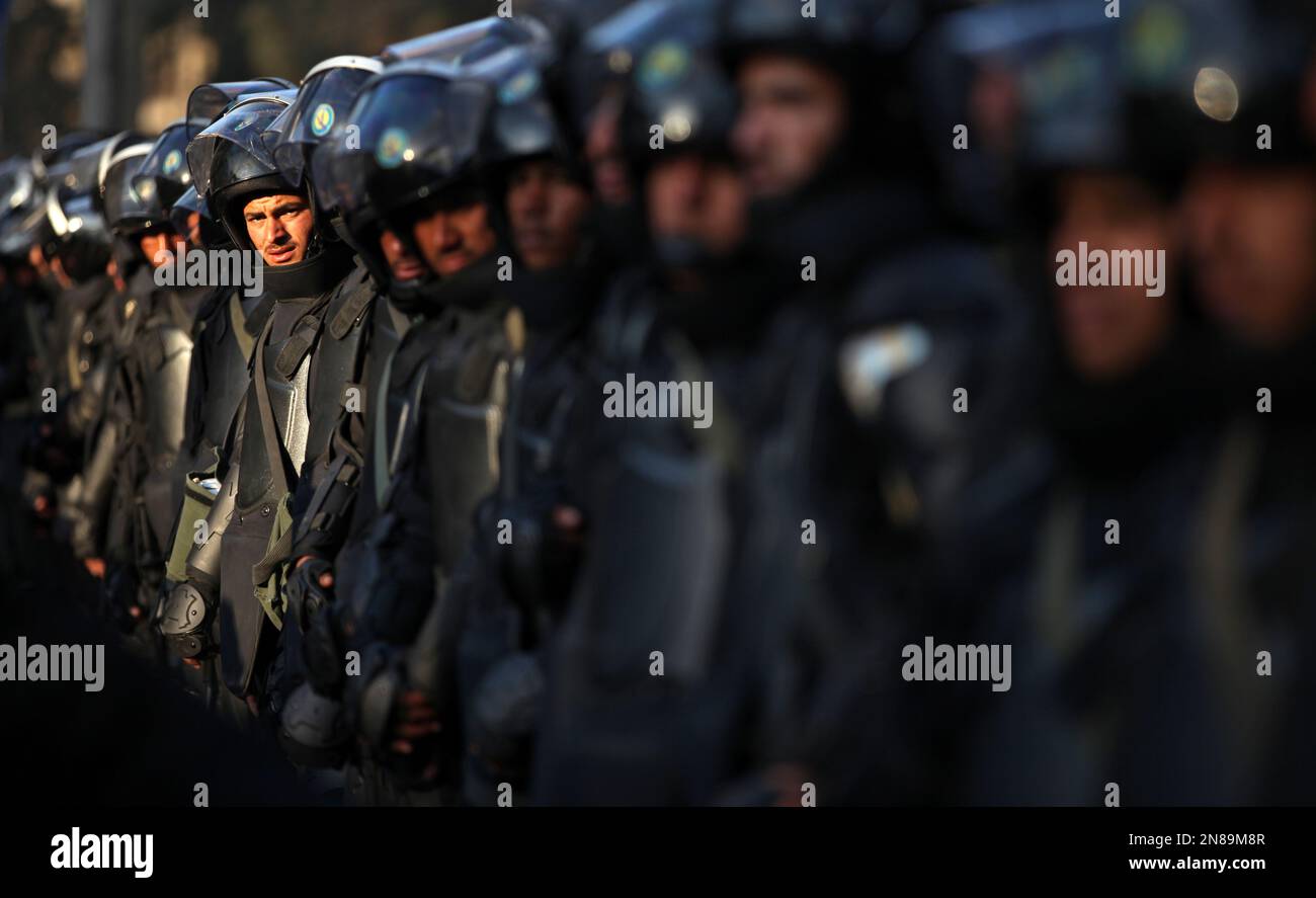 Egyptian riot police stand guard in front of the French Embassy during ...