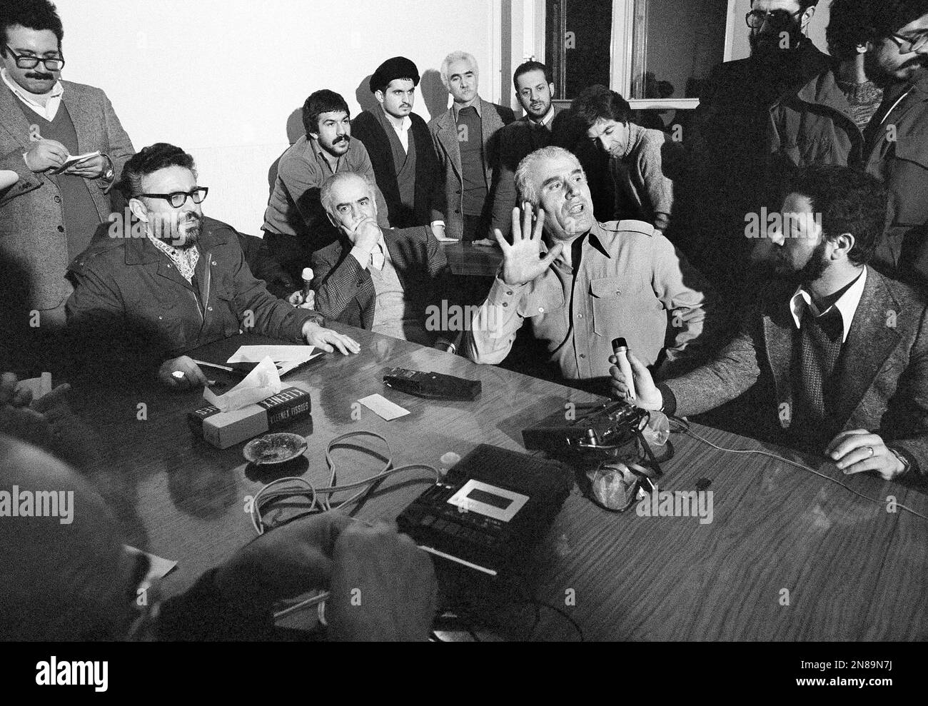 Iran Army Gen. Mehdi Rahimi (right) arrested and at news conference at Khomeini's place, Feb. 11 ...