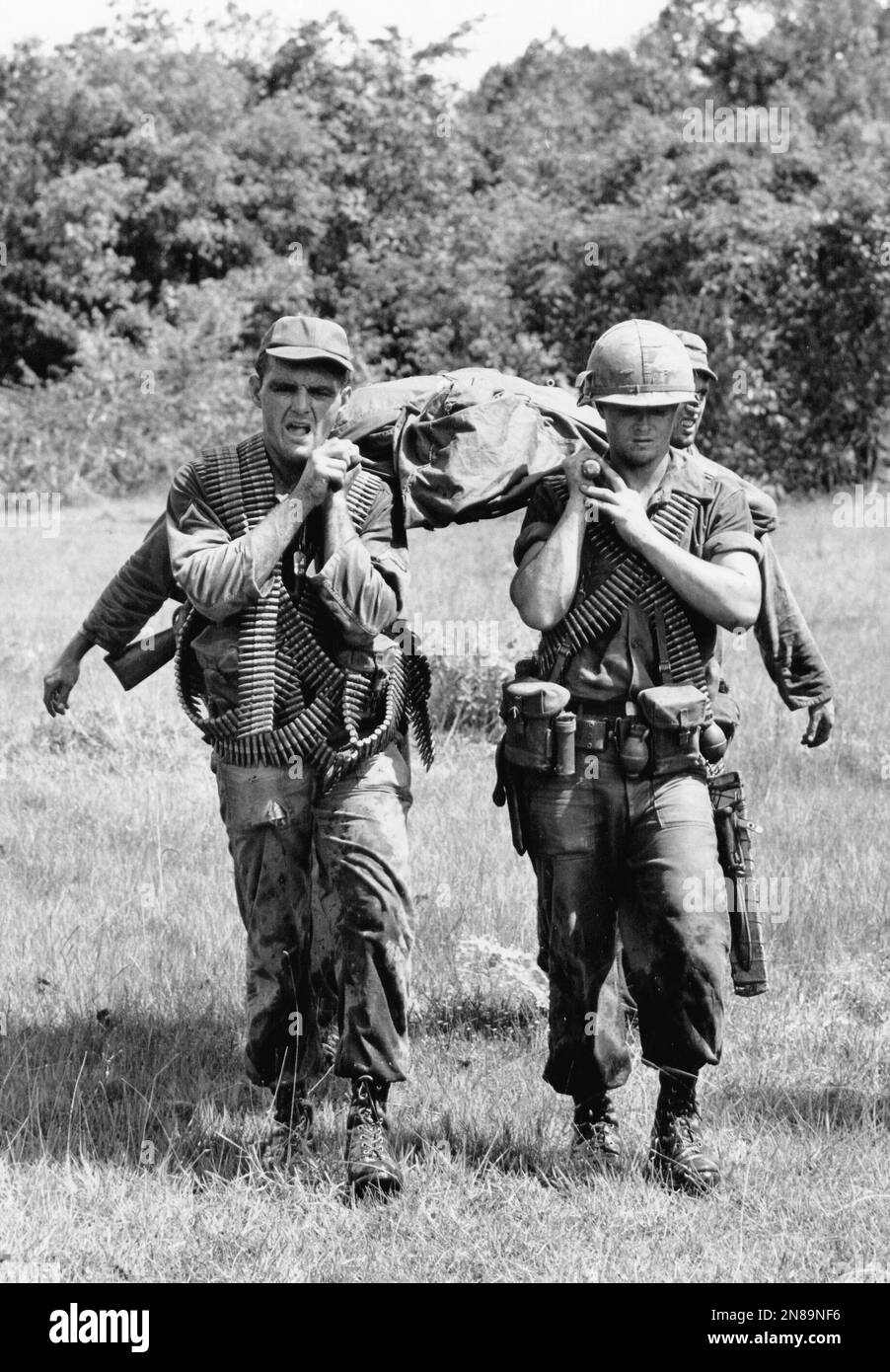 Draped with machine gun ammunition, U.S. soldiers of the 1st Infantry ...