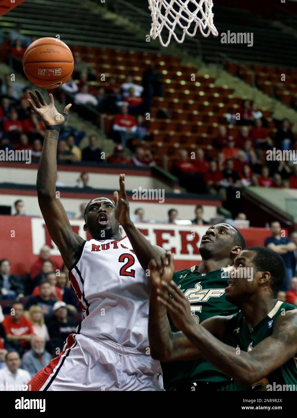 Rutgers' Dane Miller (2)shoots past South Florida's Jawanza Poland and ...