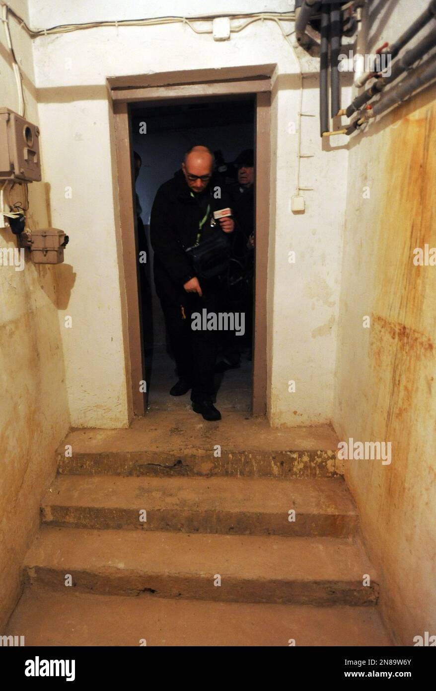 A journalist enters a communist-era death cell in a prison in Warsaw ...