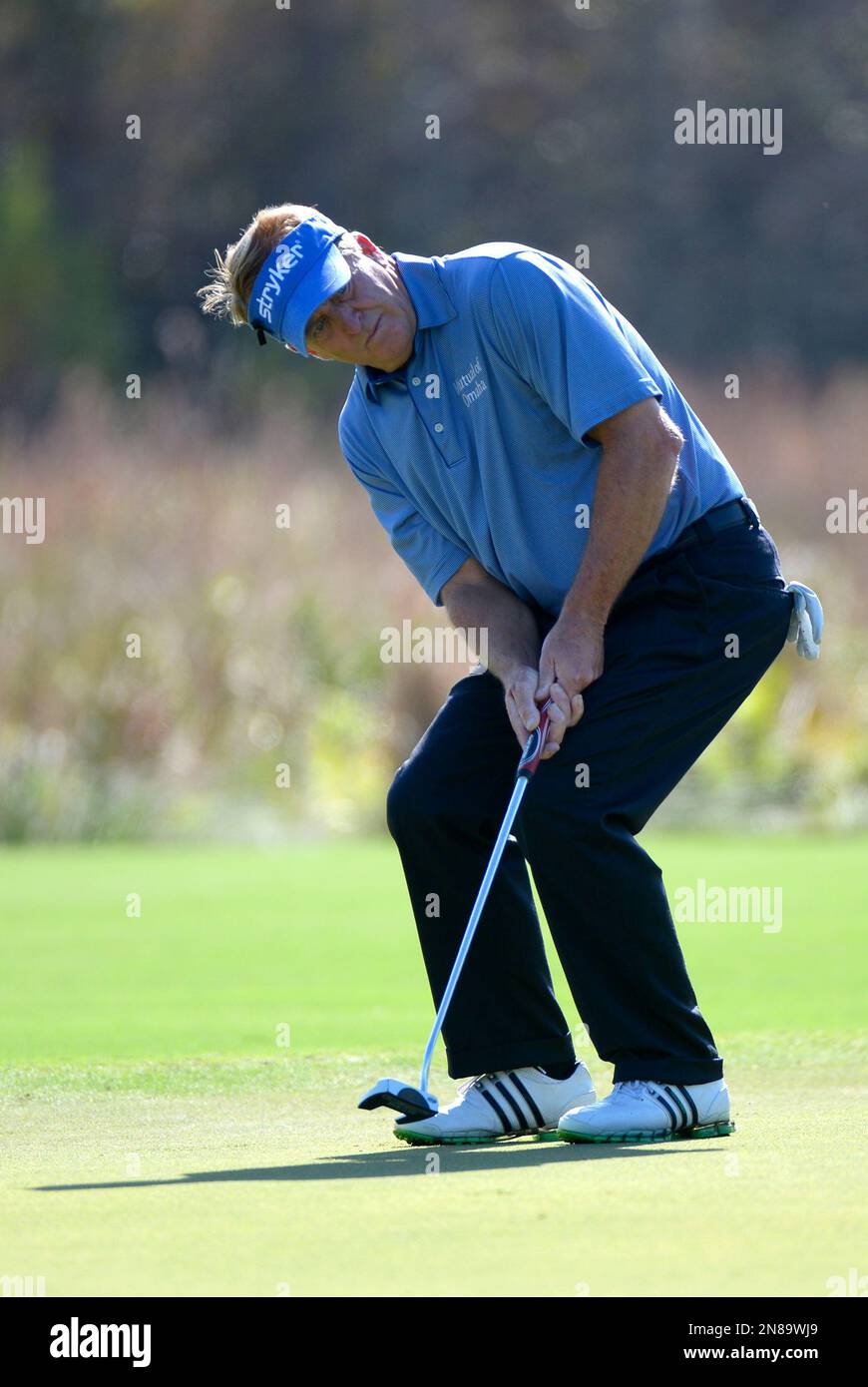 Fred Funk reacts to his putt on the eighth green during the first round ...