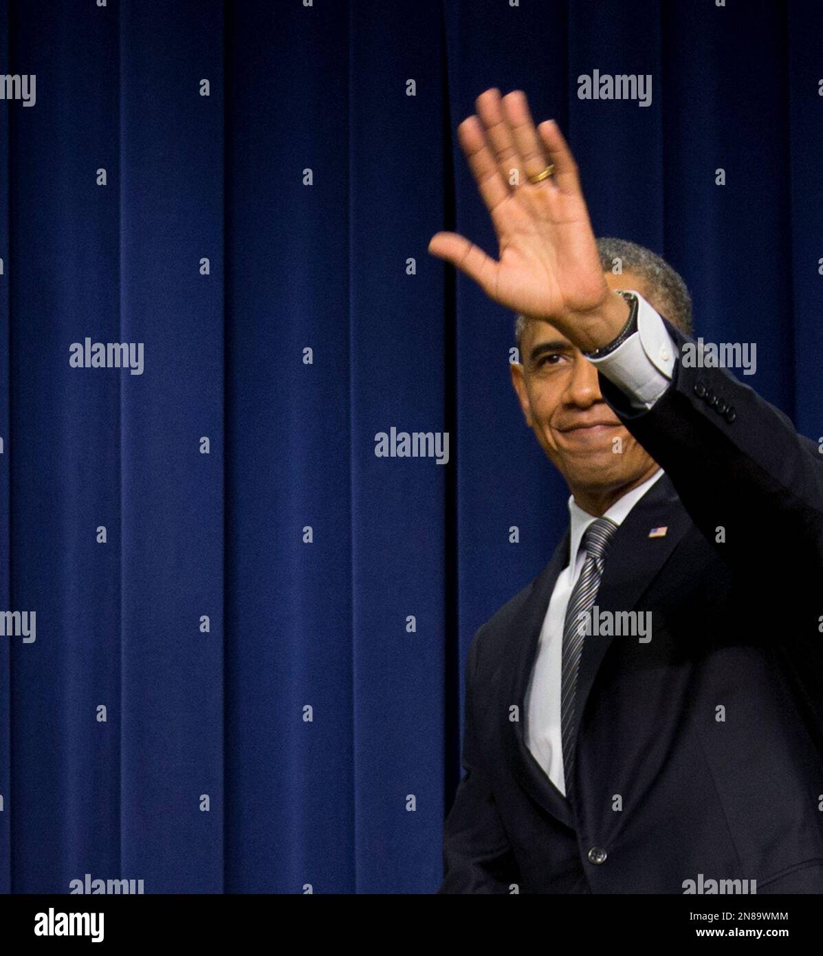 President Barack Obama waves as he leaves the stage after signing ...