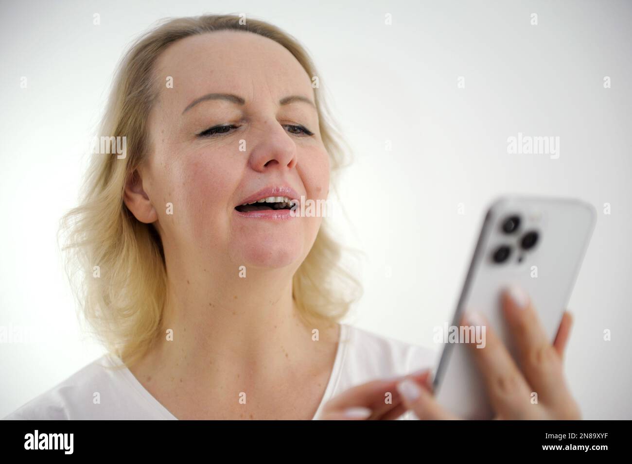 vision problems need glasses woman squinting looking at phone pushing ...