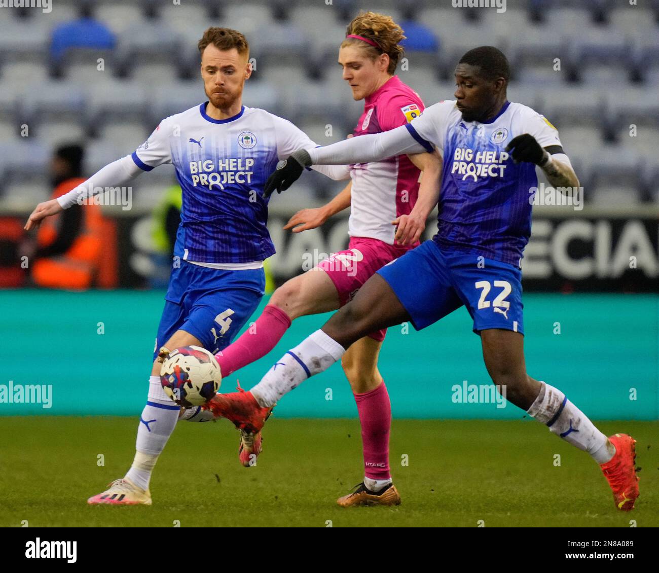 Tom Naylor #4 and Christ Tiehi #22 of Wigan Athletic competes for the ...