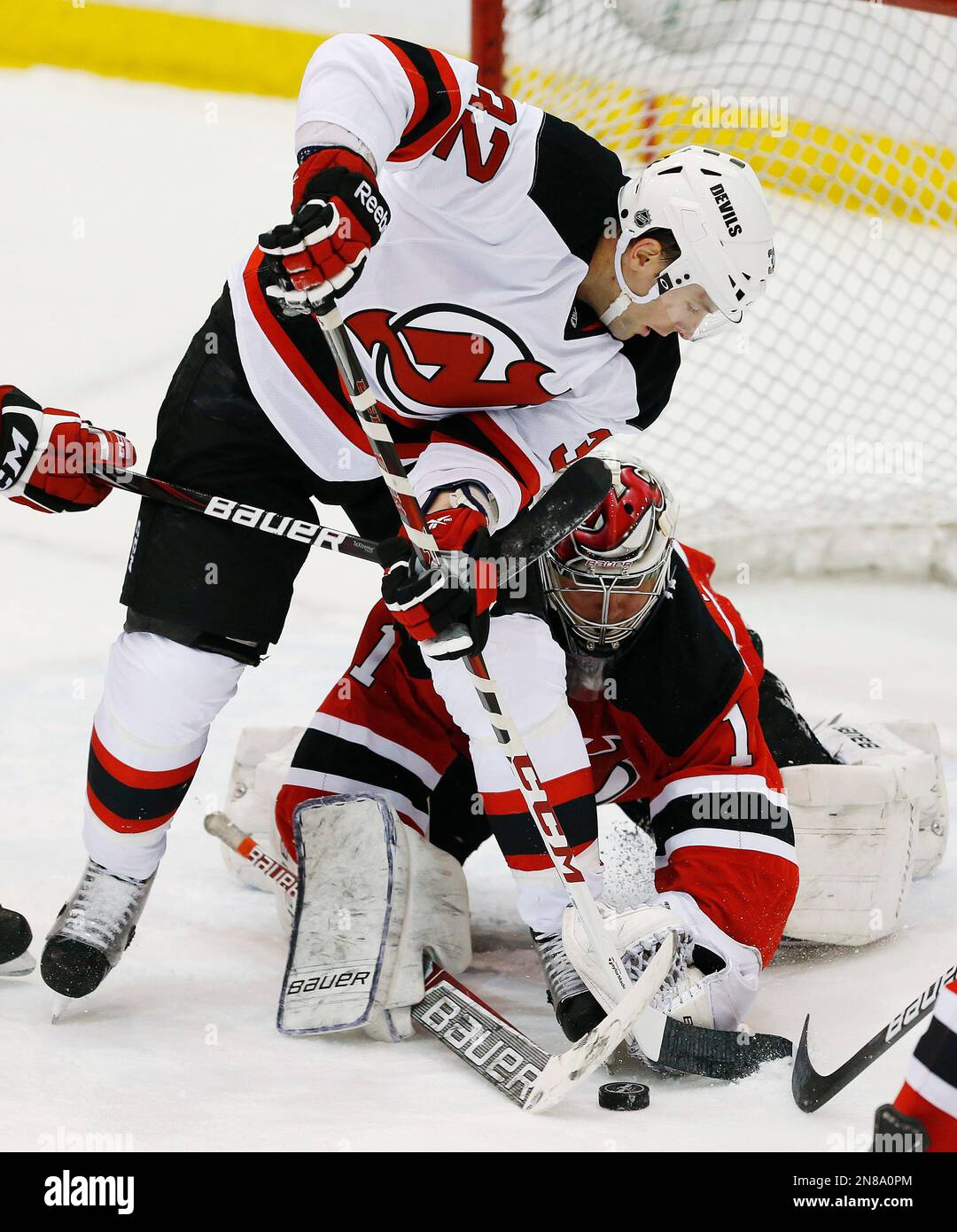 New Jersey Devils' Mathiew Darche, top, tries to score against Devils ...